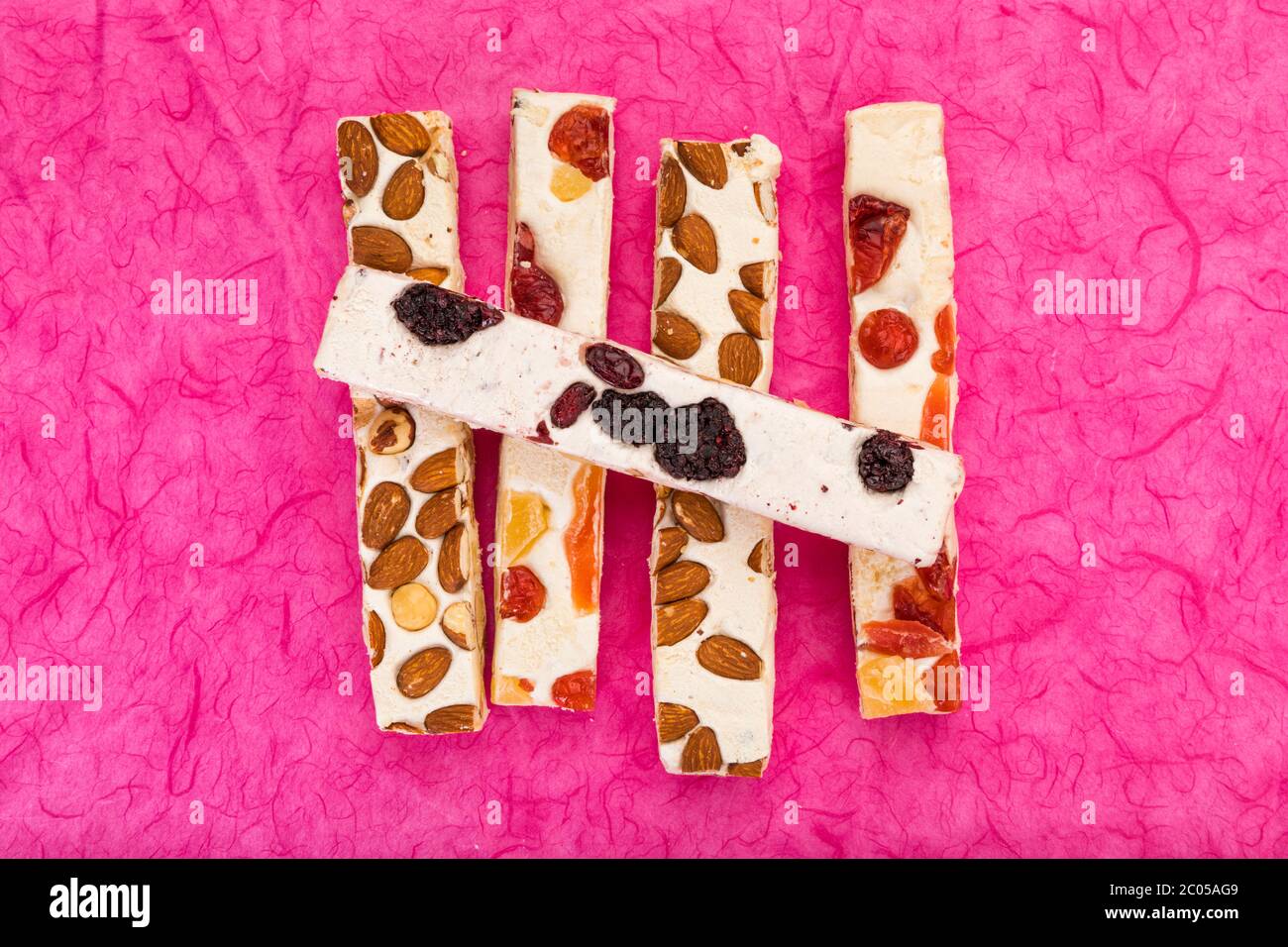 Variety of turron blocks with hazelnuts, almonds, dried berries and ...