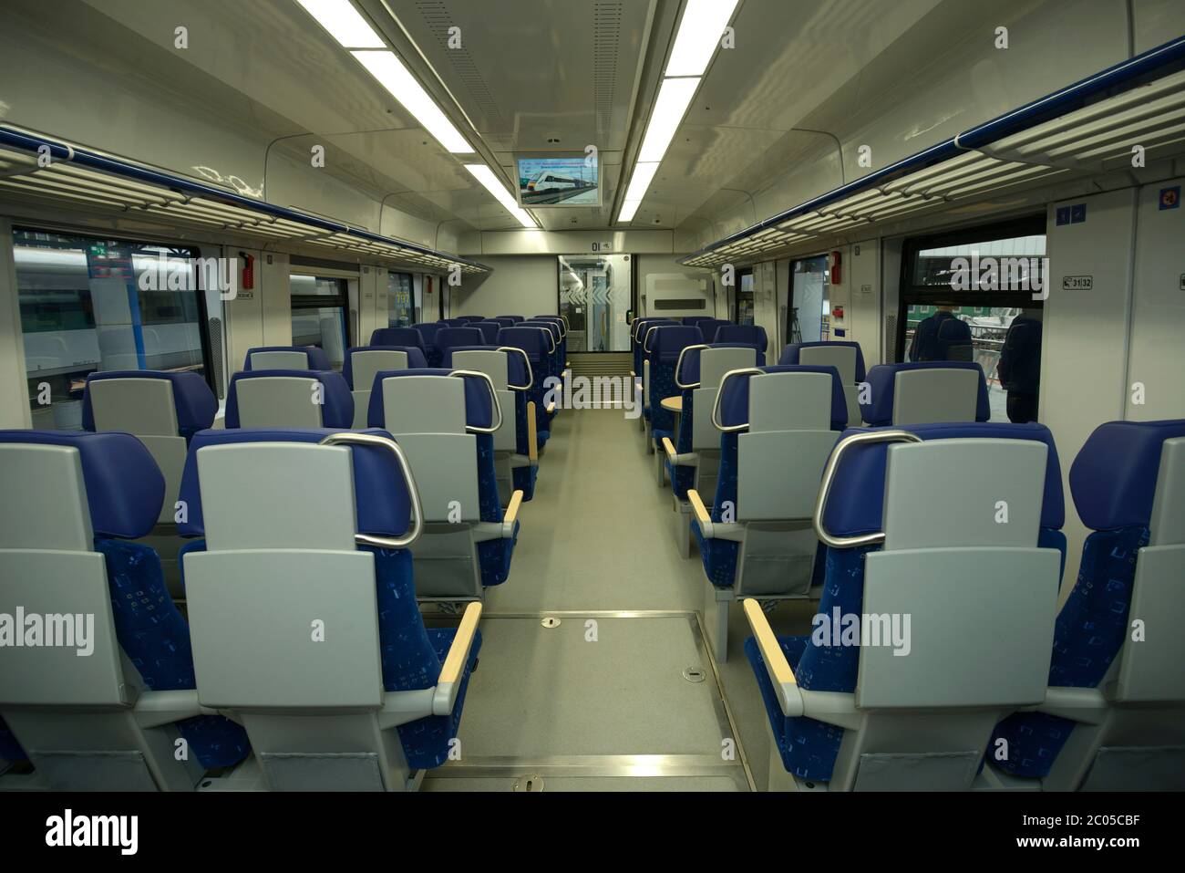 Empty wagon of a commuter train, seats and doors on a background Stock ...
