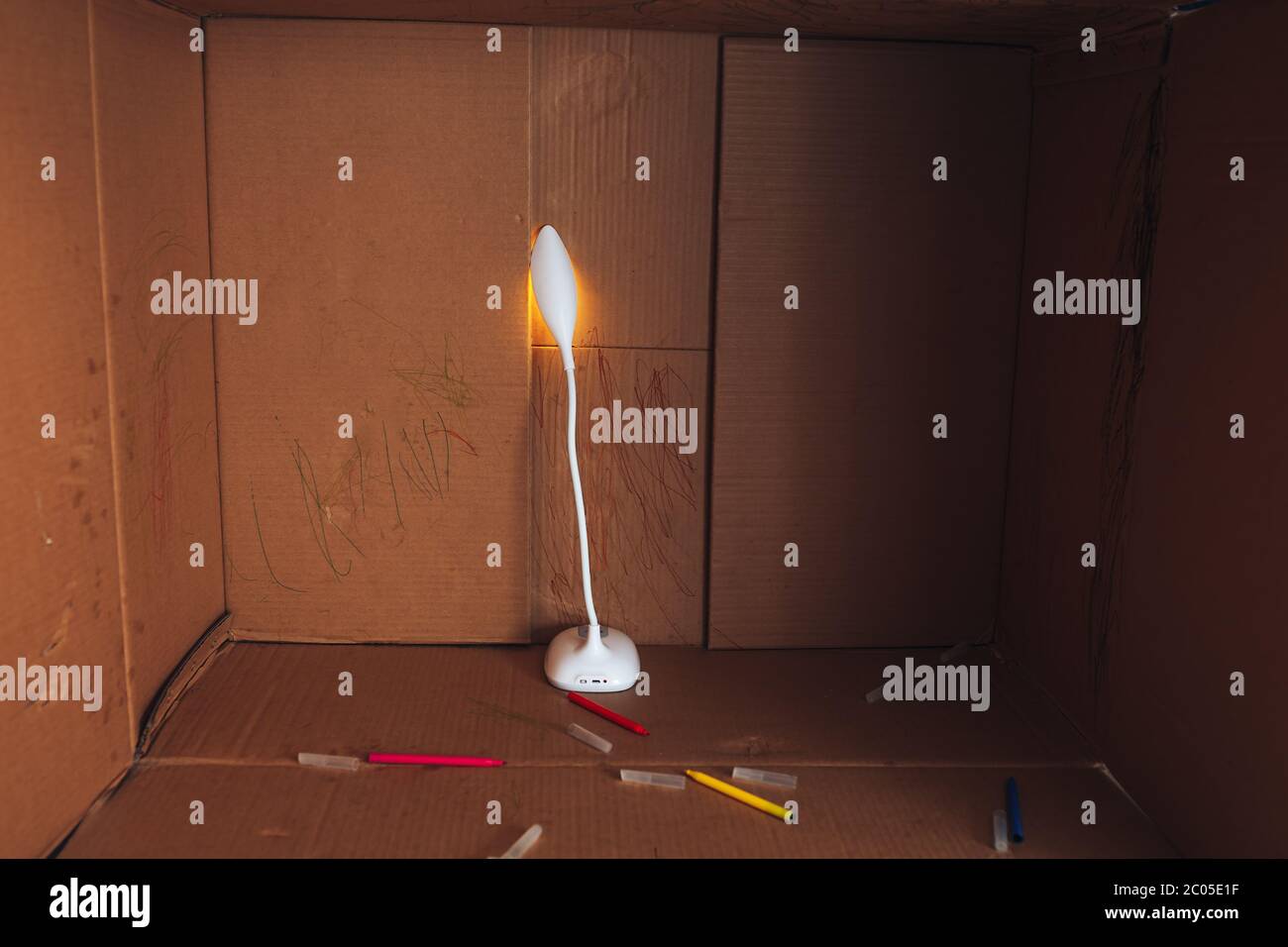 Markers and lamp are in large box Stock Photo - Alamy
