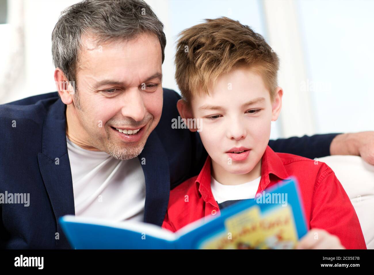 Happy kid reading book hi-res stock photography and images - Alamy