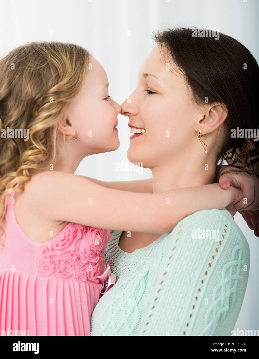 Mother and daughter touching with noses Stock Photo - Alamy