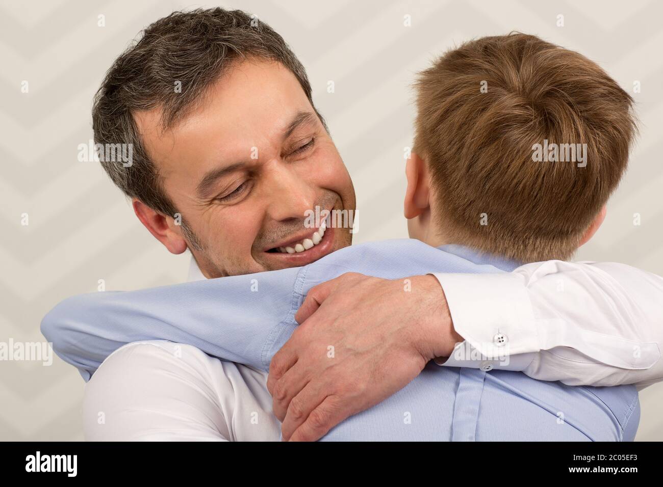 Father giving hugs to dear son Stock Photo - Alamy