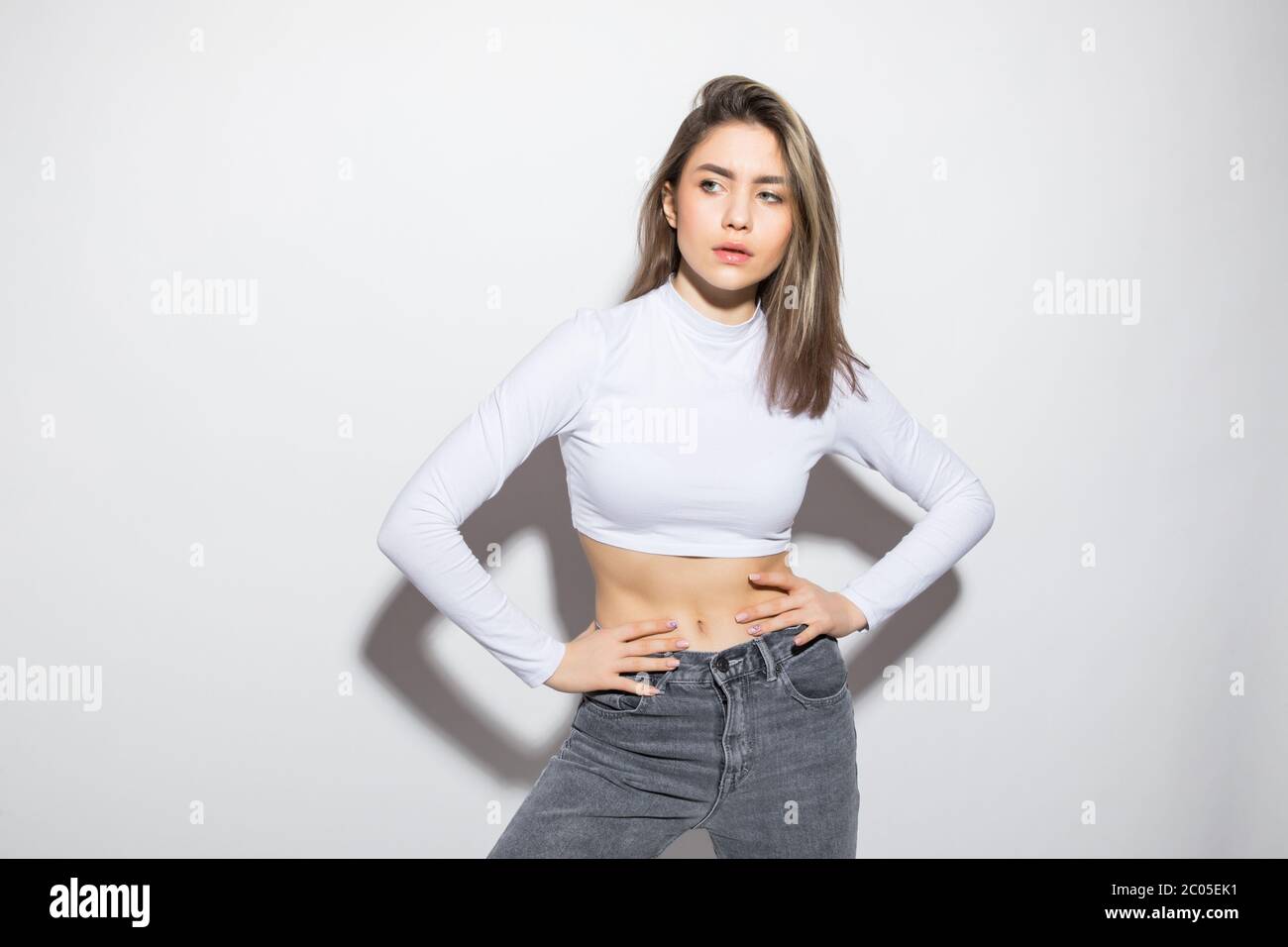 Beautiful female model fashion portrait standin on white background ...