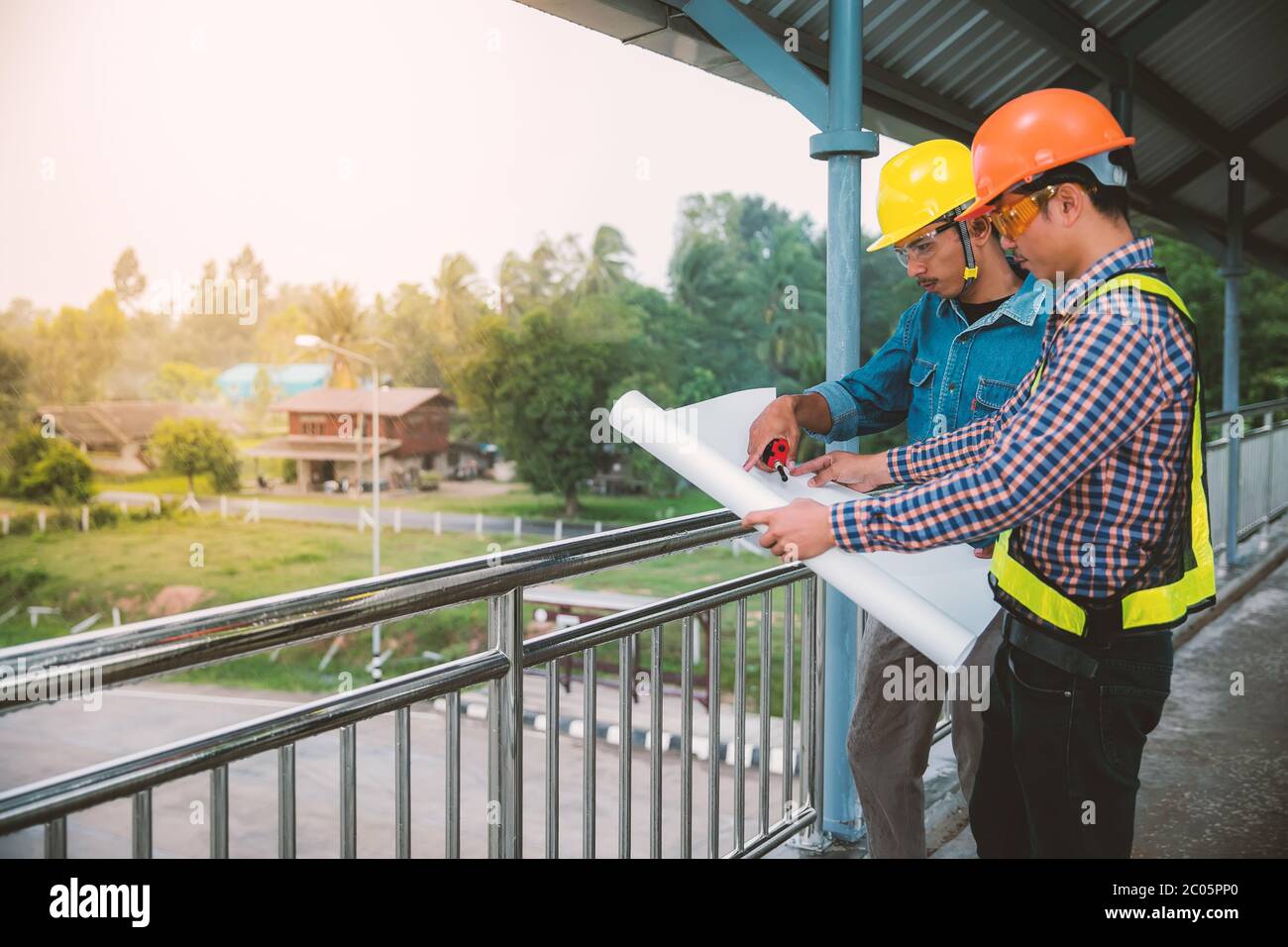 Two engineers stand hand in hand on bridge Stock Photo - Alamy