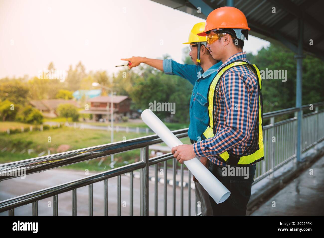 Two engineers stand hand in hand on bridge Stock Photo - Alamy