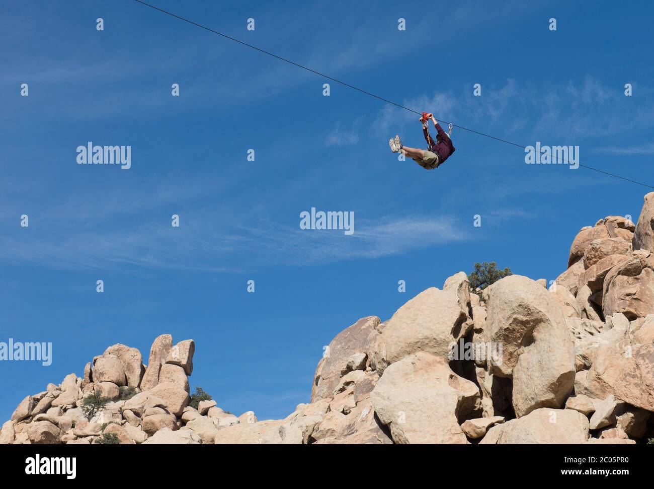 People in the mountains enjoying a zip line in La Rumorosa mountains ...