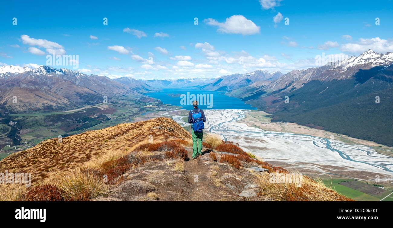 Hiker on the summit of Mount Alfred, views of Lake Wakatipu and ...