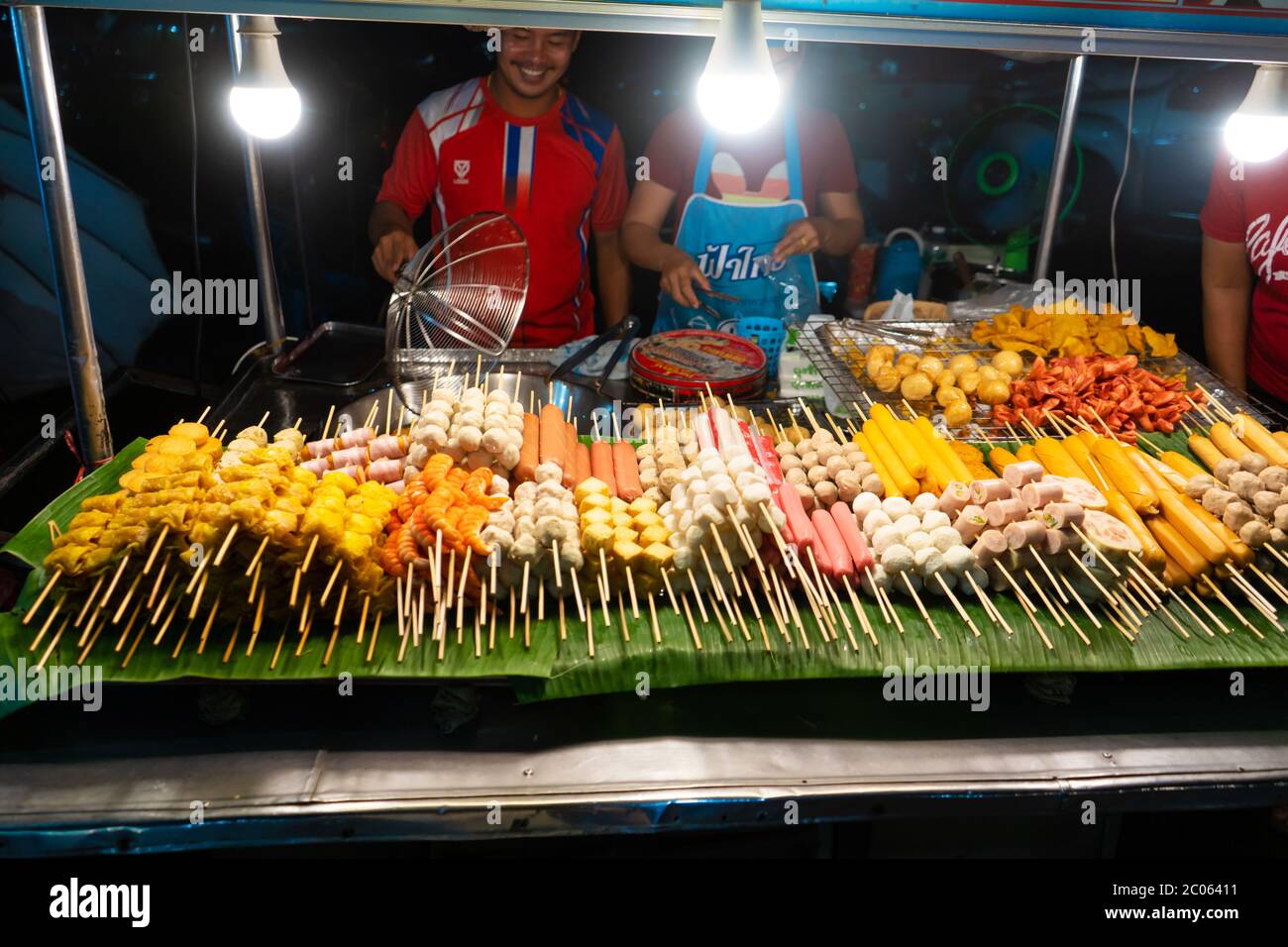 Asian food. Different mini barbecue counter at night street food market ...