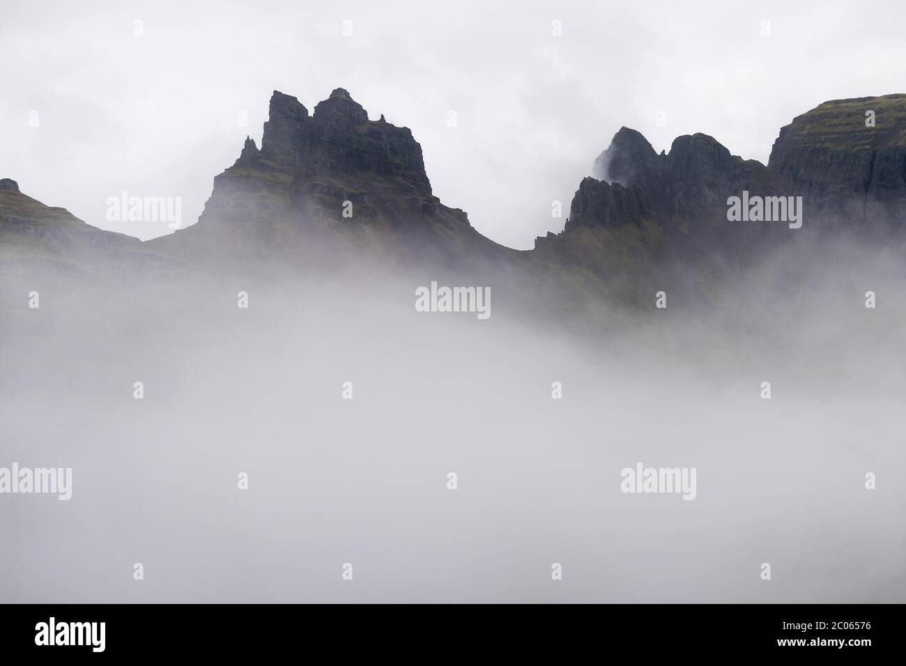 Cloud-covered rugged mountain peaks, East fjords, Iceland Stock Photo ...