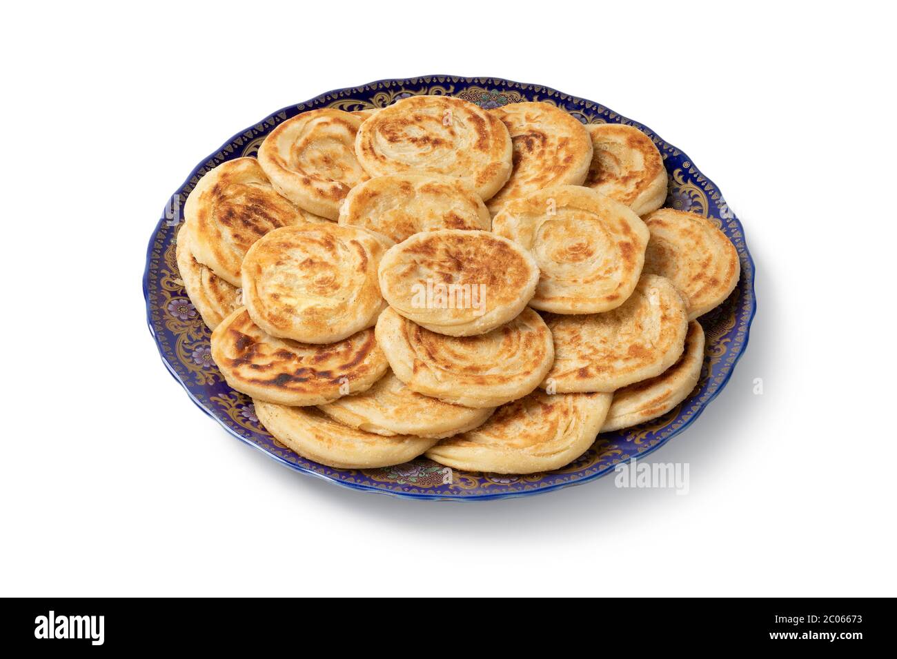 Fresh baked meloui, Moroccan pancakes, on a plate isolated on white ...