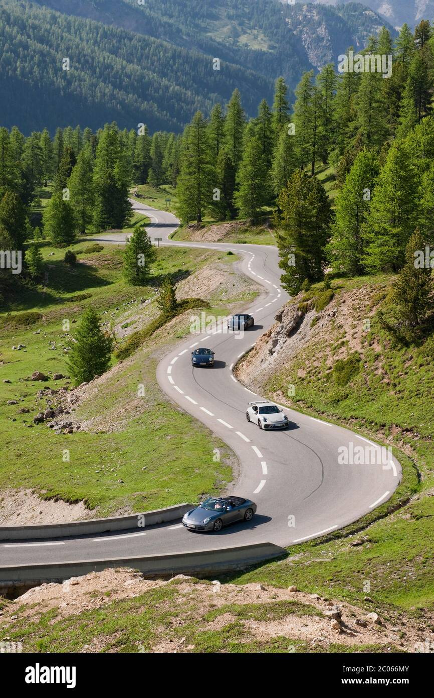 Sports cars on a winding Alpine road, Route des Grandes Alpes, Hautes ...