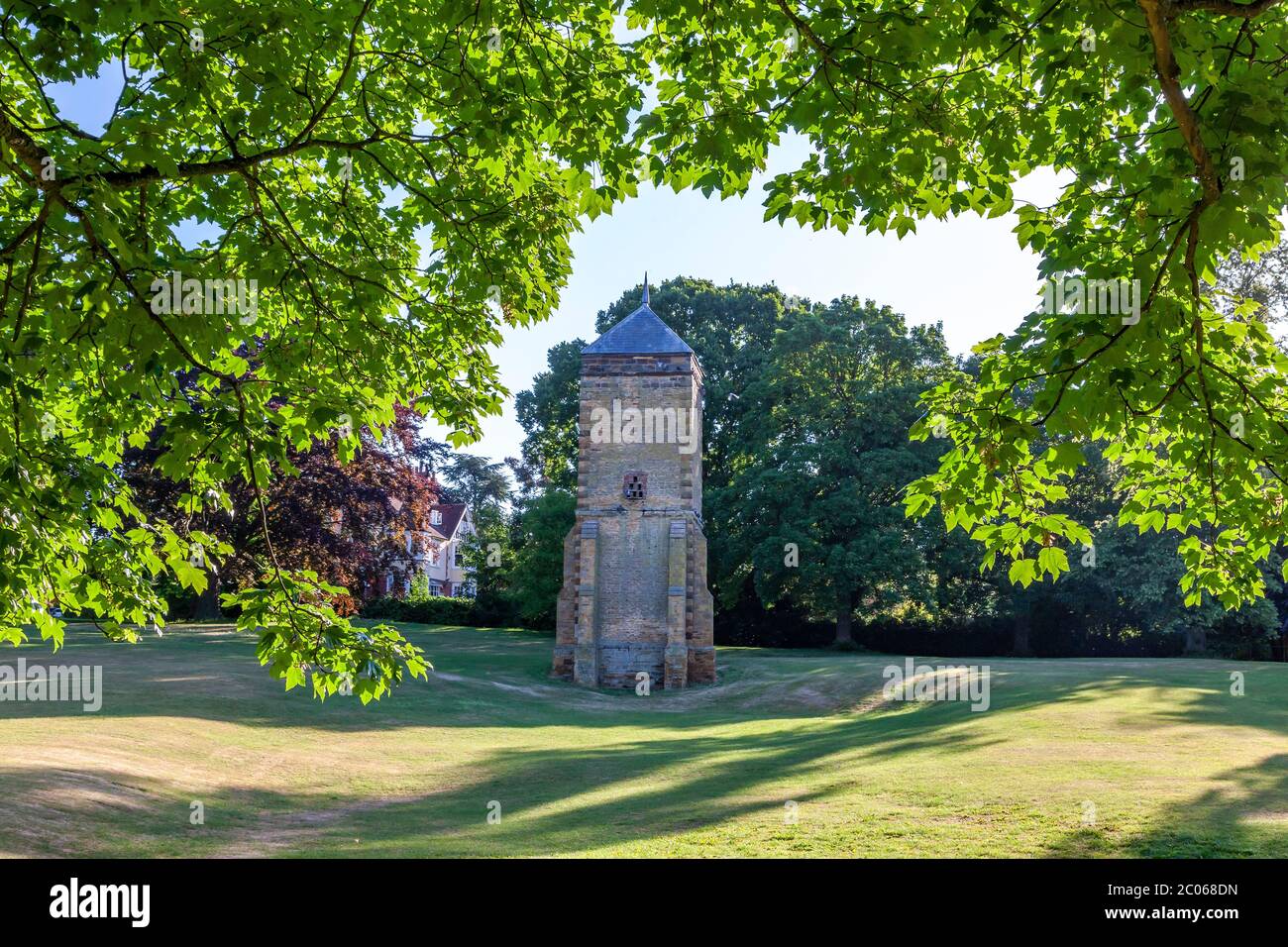 The old stone Pigeonry (pigeon loft) framed by fresh green leaves from ...