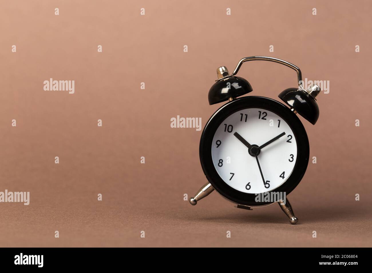 black vintage alarm clock falling to the floor with a colored ...