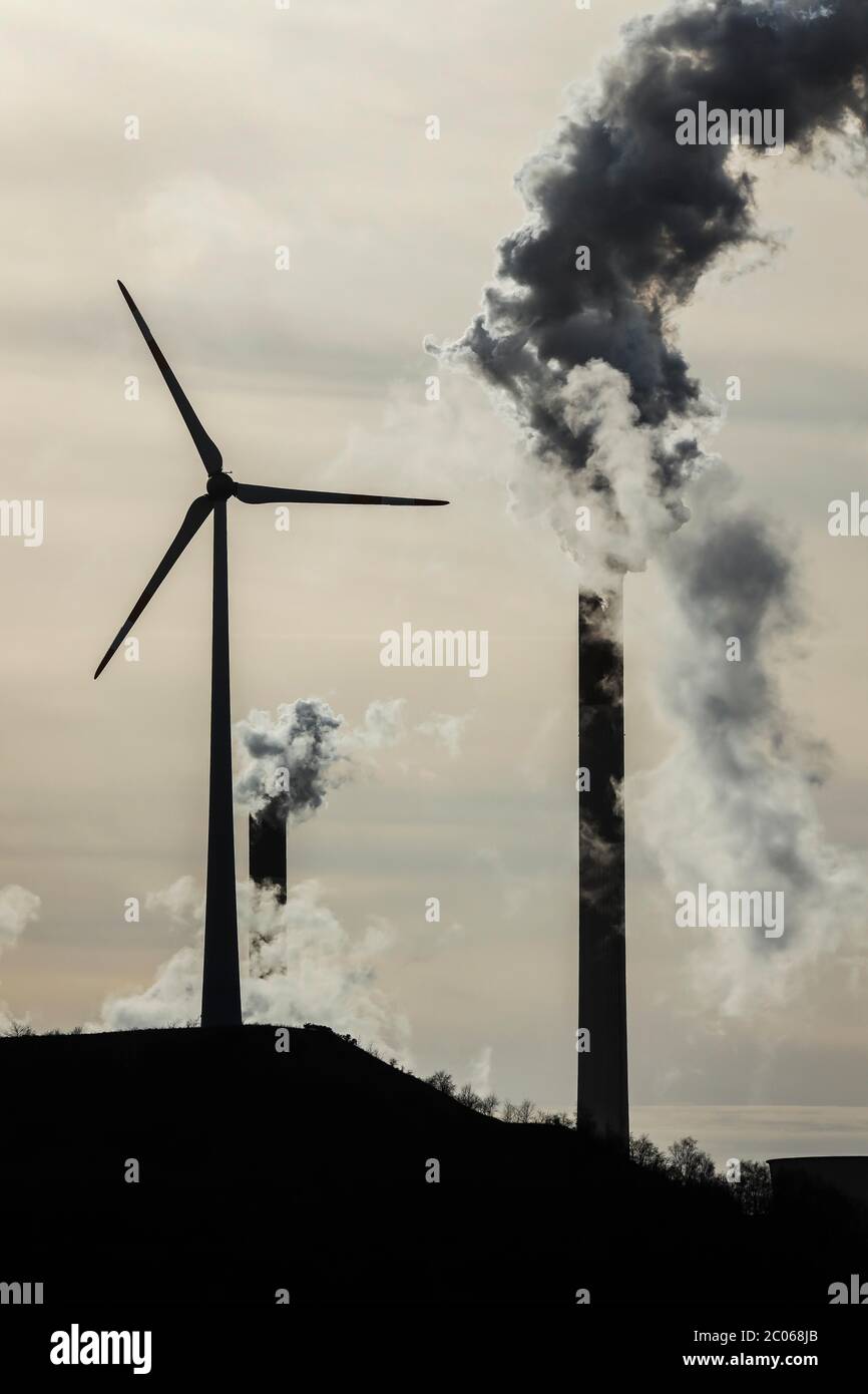Wind turbine and smoking chimneys at the Uniper coal-fired power plant ...