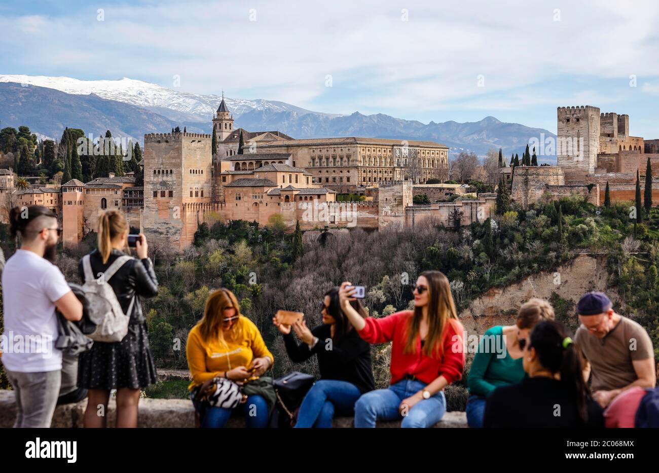 Tourists taking pictures of the Moorish city castle Alhambra, Nasrid ...