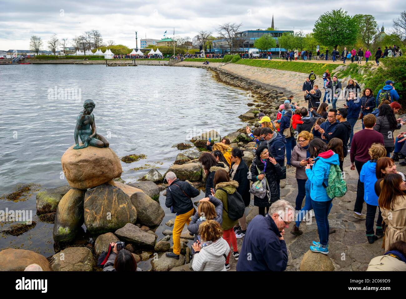 Tourists in front of the Little Mermaid, landmark of Copenhagen, Port ...