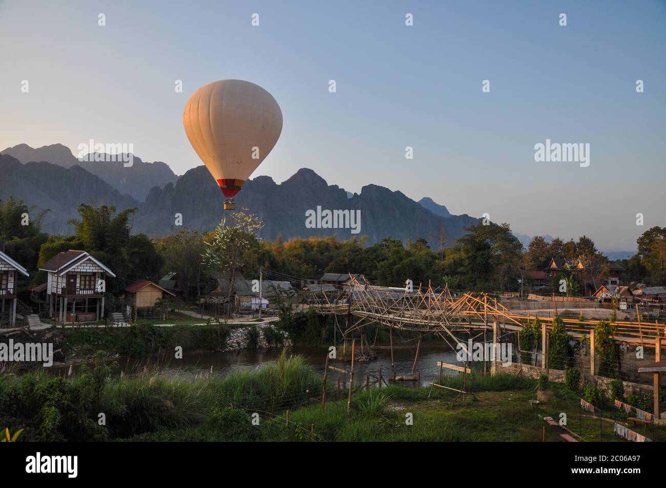 Hot Air Balloon rising at Sunset in Vang Vieng Stock Photo - Alamy