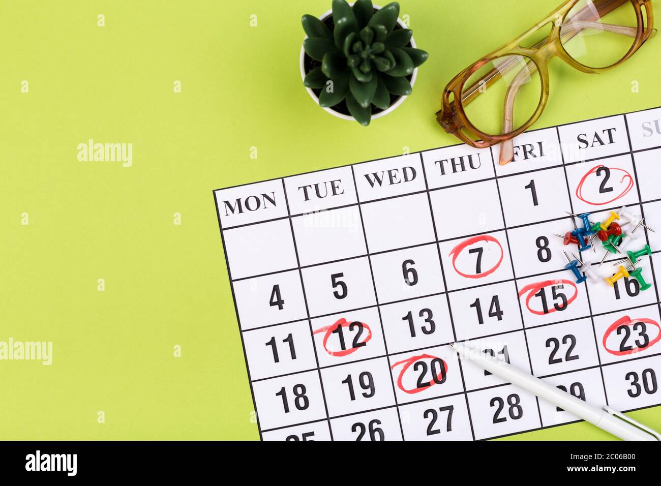 Open calendar on the table with green background, planning a business ...