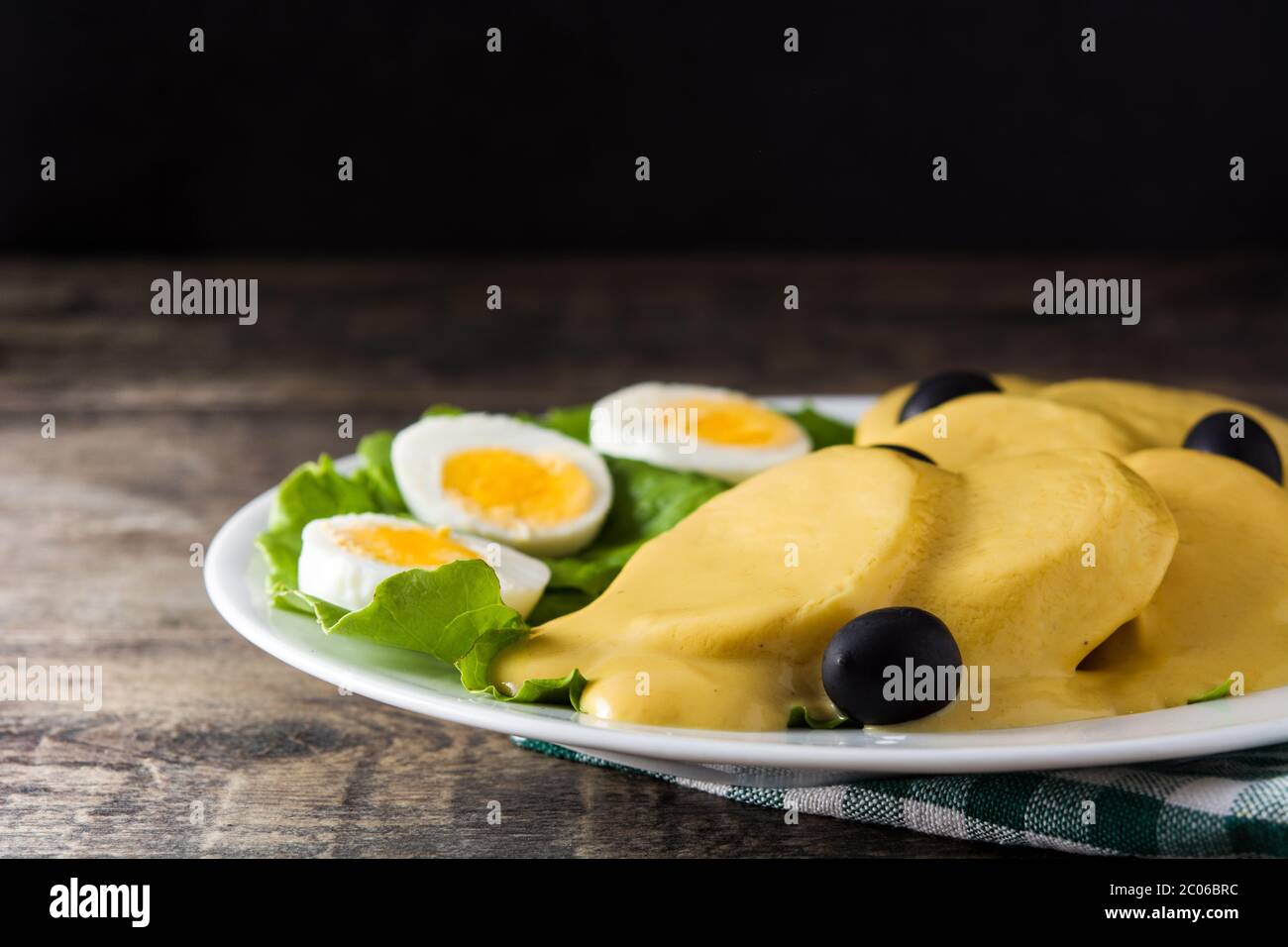 Traditional Peruvian papa a la huancaina on wooden table Stock Photo ...