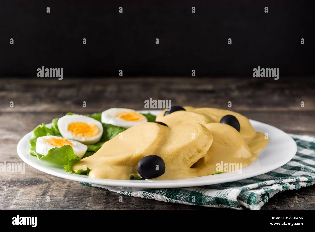 Traditional Peruvian papa a la huancaina on wooden table Stock Photo ...