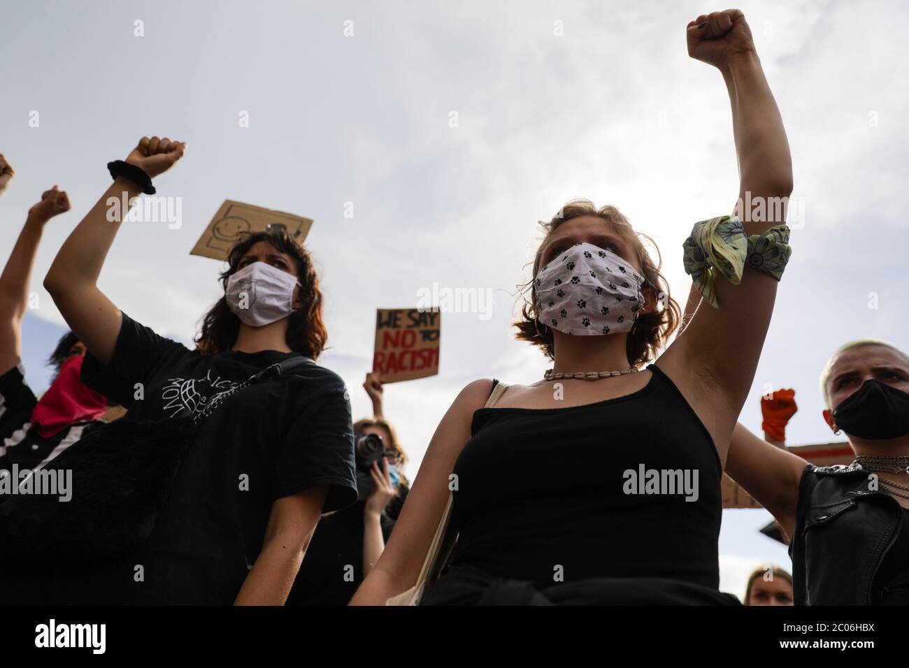 Protesters in a medical masks hold their fists up during 'Black Lives ...
