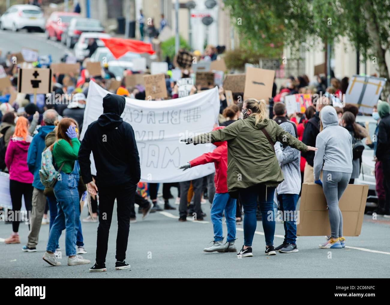 Newport, Wales, UK. 11th June, 2020. People stretch their arms out to ...