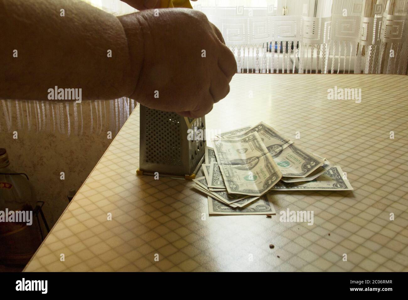 Men's hands are rubbing dollars into coins Stock Photo - Alamy