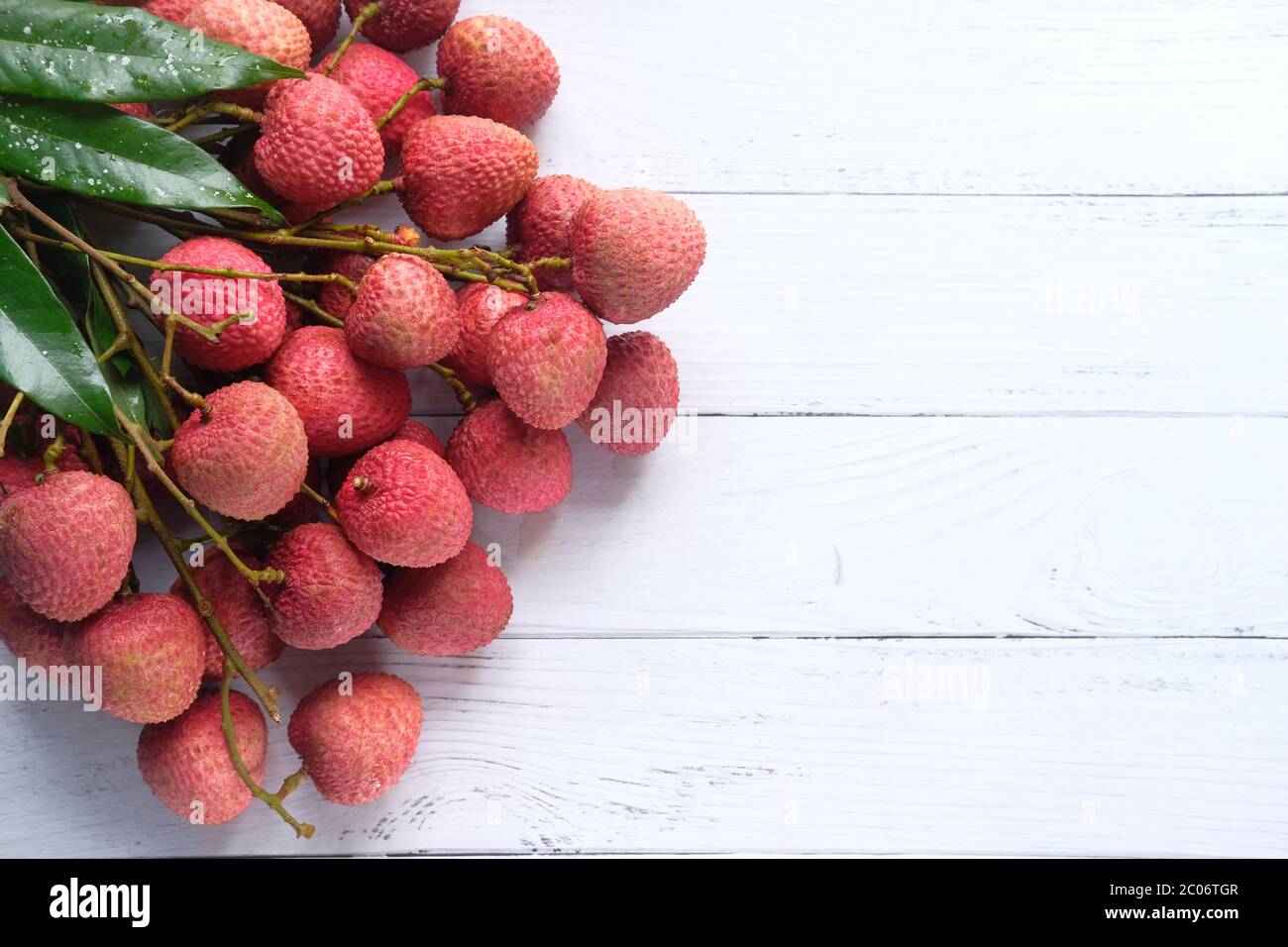 Lychee with leaves isolated on white background Stock Photo - Alamy