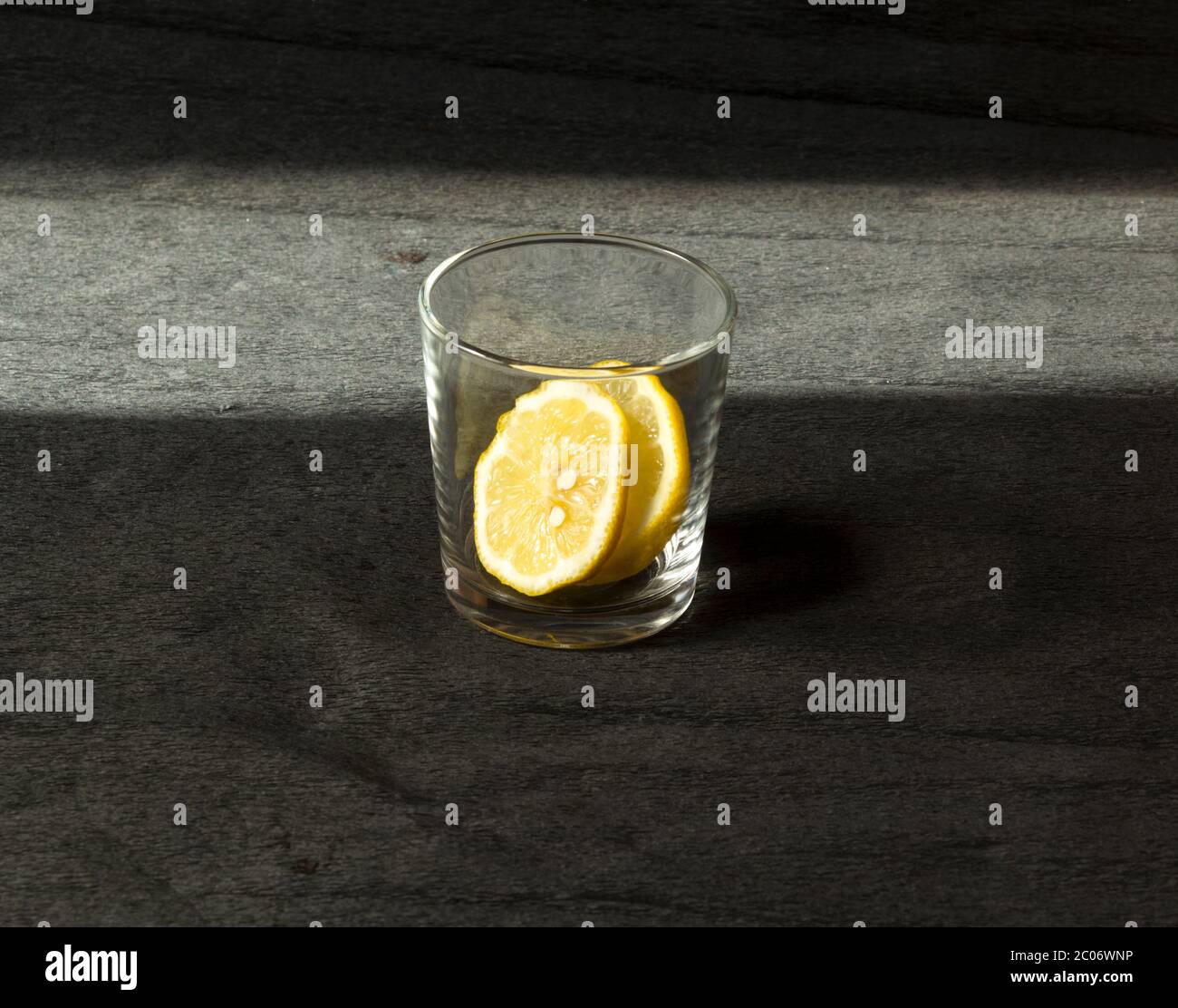 Sliced slices of lemon lie in a transparent glass Stock Photo - Alamy