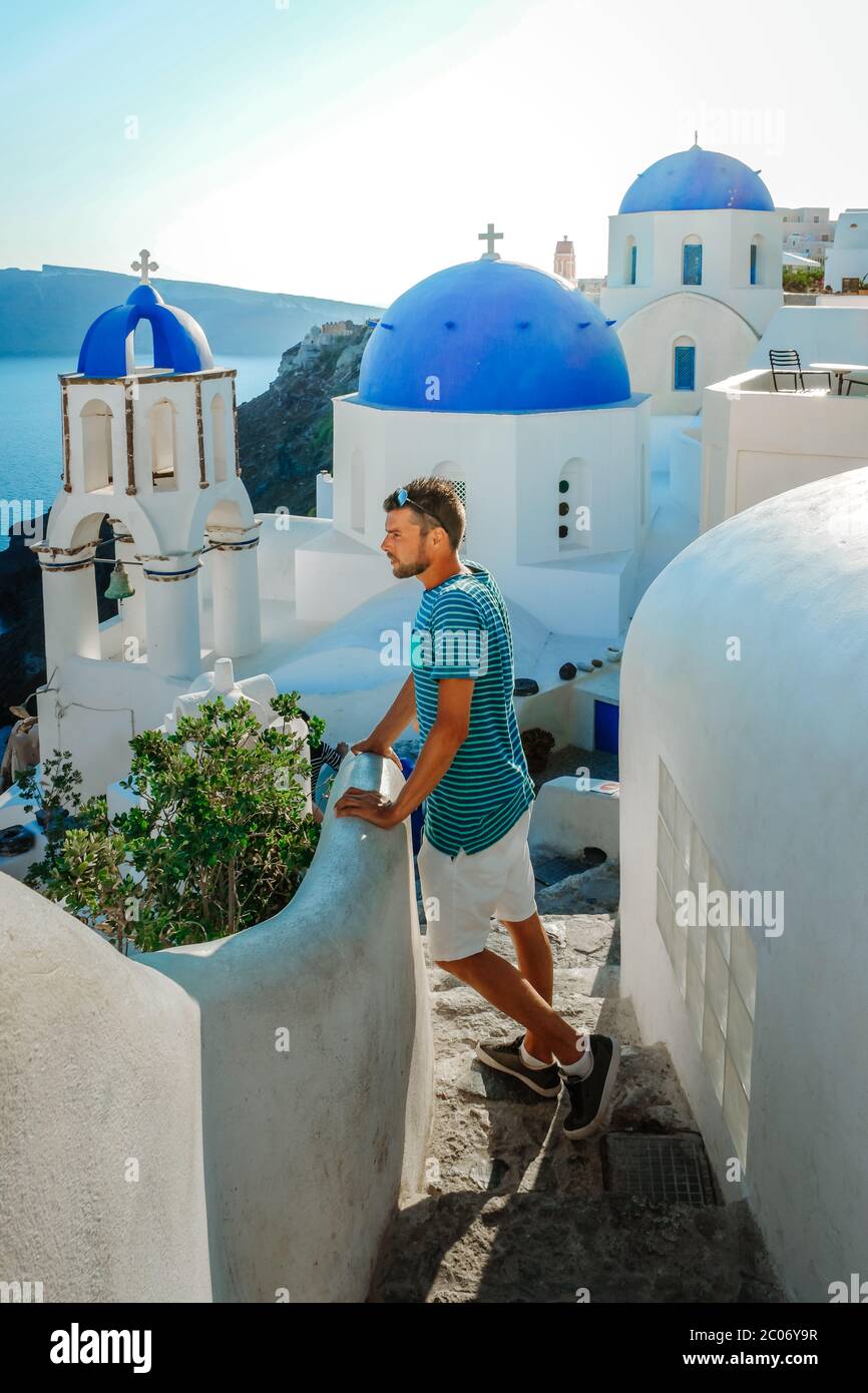 Santorini greece, young men on a luxury vacation at the Greek Island of ...