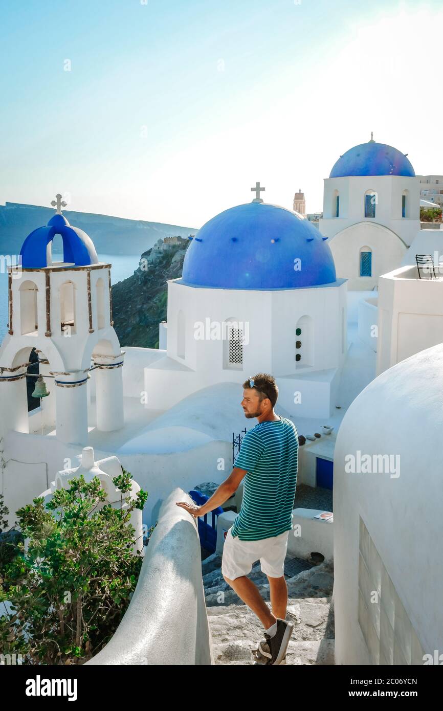 Santorini greece, young men on a luxury vacation at the Greek Island of ...