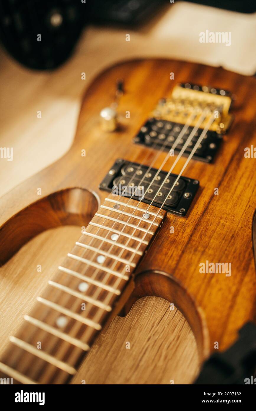 Wooden electric guitar closeup on table Stock Photo - Alamy