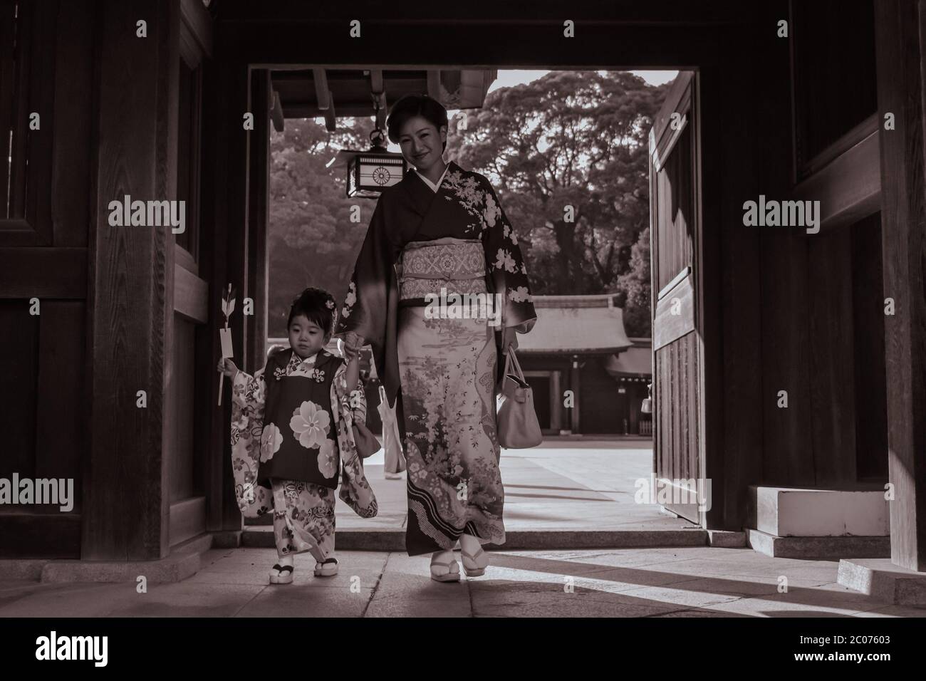 Japanese Mother And A Daughter In Traditional Kimonos On A Sunday Walk