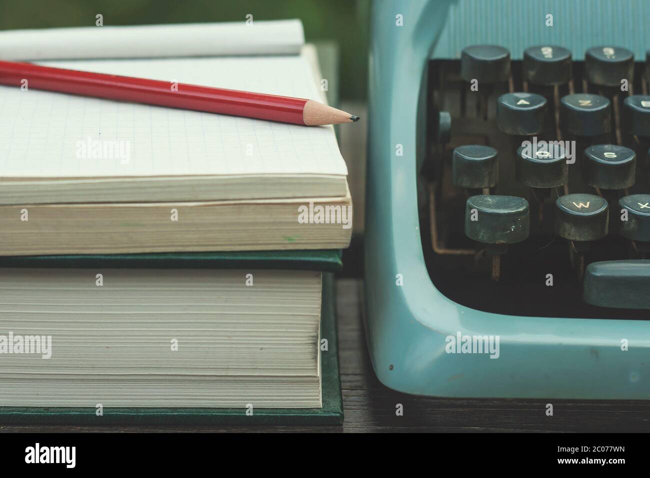 Blue vintage typewriter and old books Stock Photo - Alamy