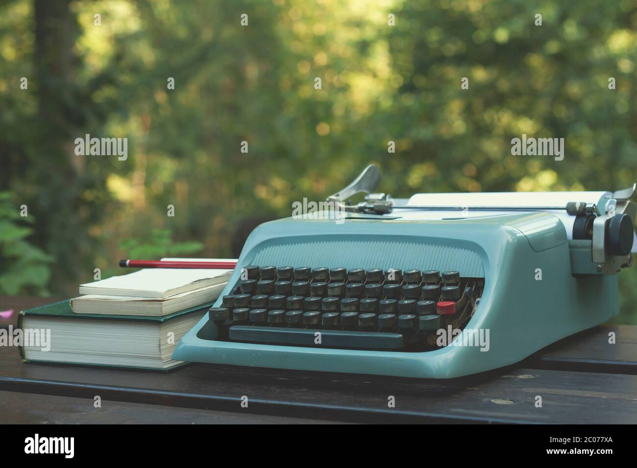 Blue vintage typewriter and old books Stock Photo - Alamy