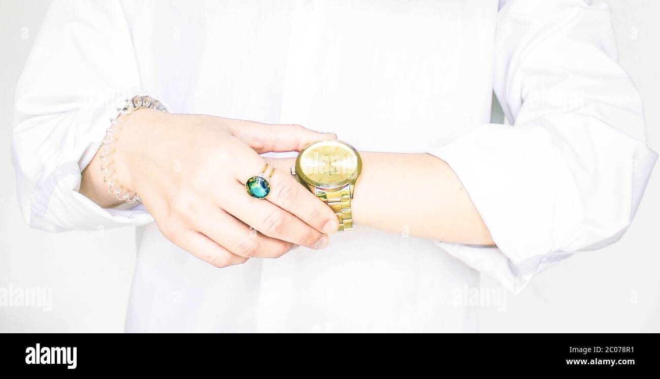 female hands looking at the time on the hand watch Stock Photo - Alamy