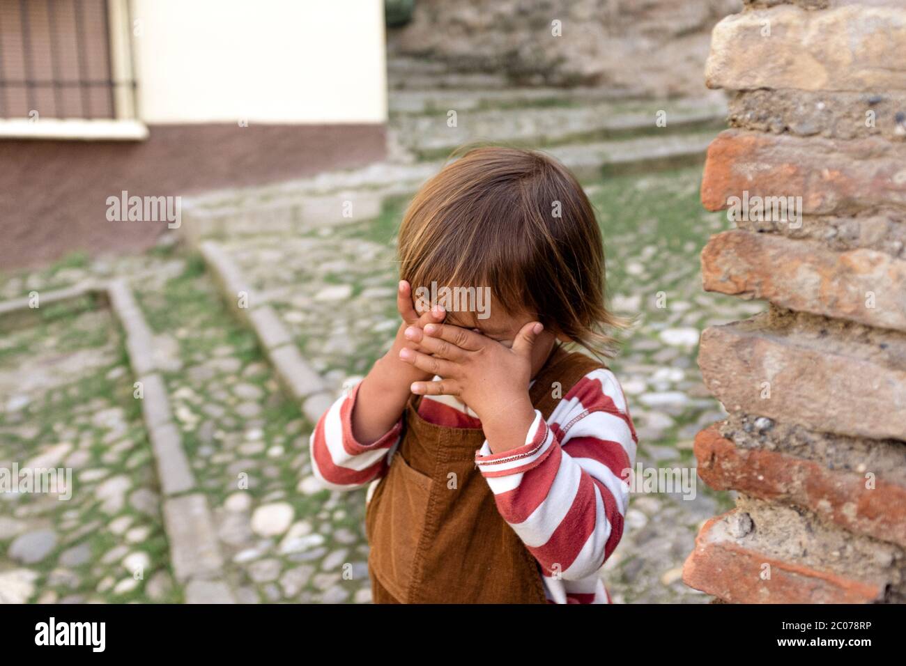 Little baby boy covers eyes with hands playing hide and seek Stock ...