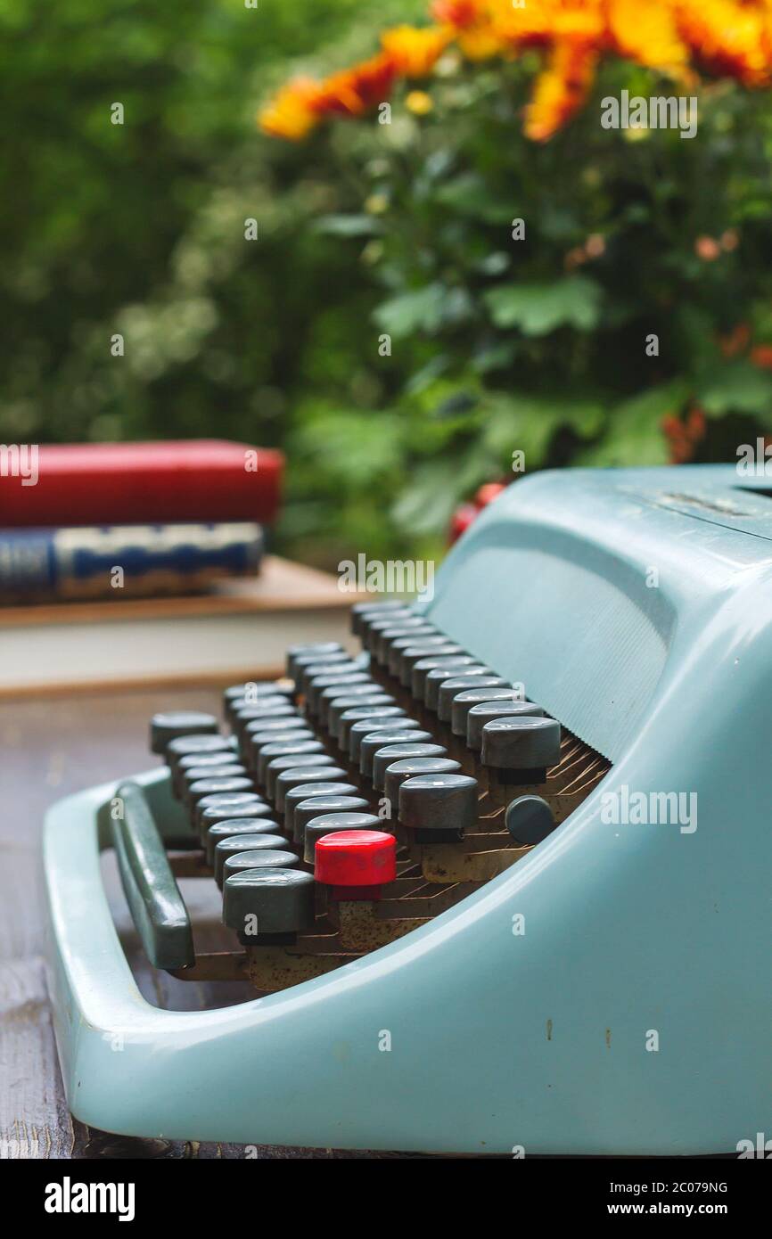 Old vintage blue typewriter on the garden table Stock Photo - Alamy