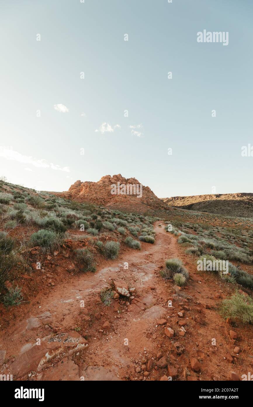 well worn hiking trail winds its way through red rocks and shrubs Stock ...