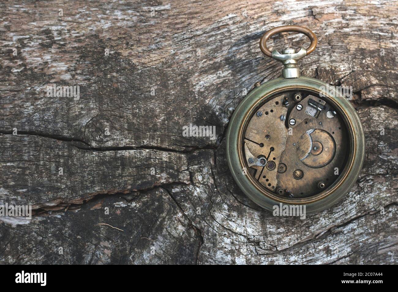 old pocket watch engine on a rustic wooden background Stock Photo - Alamy
