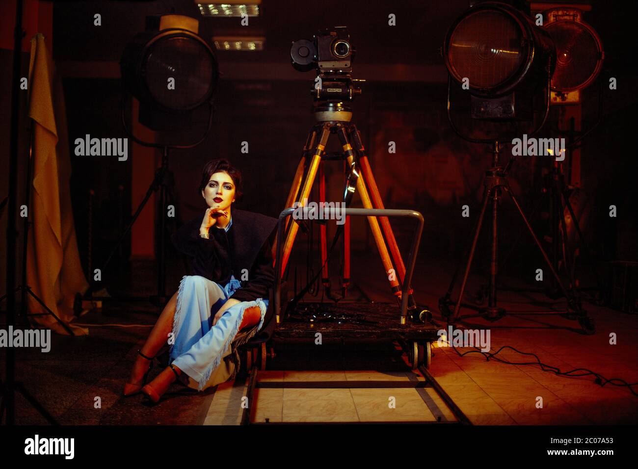 Beautiful female as actress with camera Stock Photo - Alamy