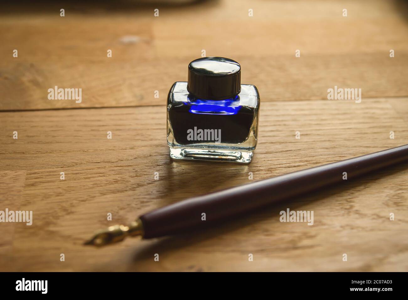 Blue ink and fountain pen on a desk Stock Photo - Alamy