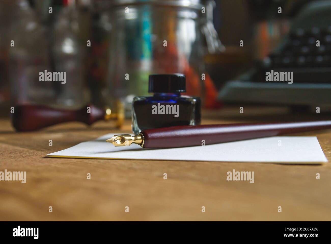 Blue ink, blank paper and fountain pen on a desk Stock Photo - Alamy