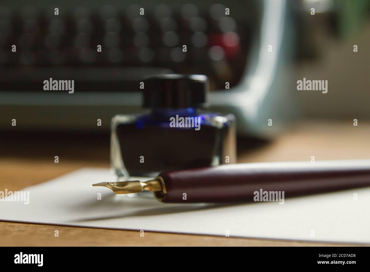 Blue ink and fountain pen on a desk Stock Photo - Alamy