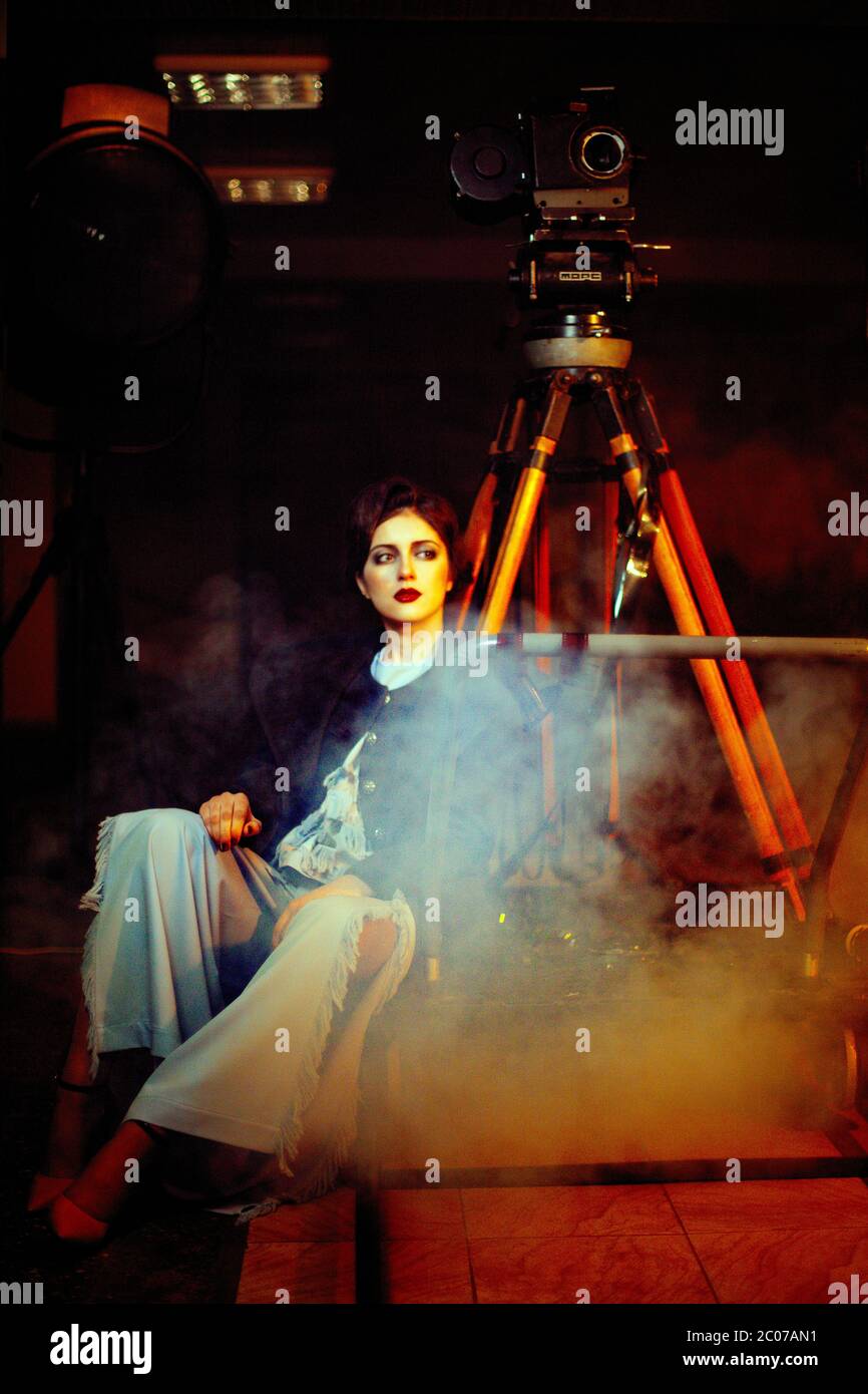 Beautiful female as actress with camera Stock Photo - Alamy