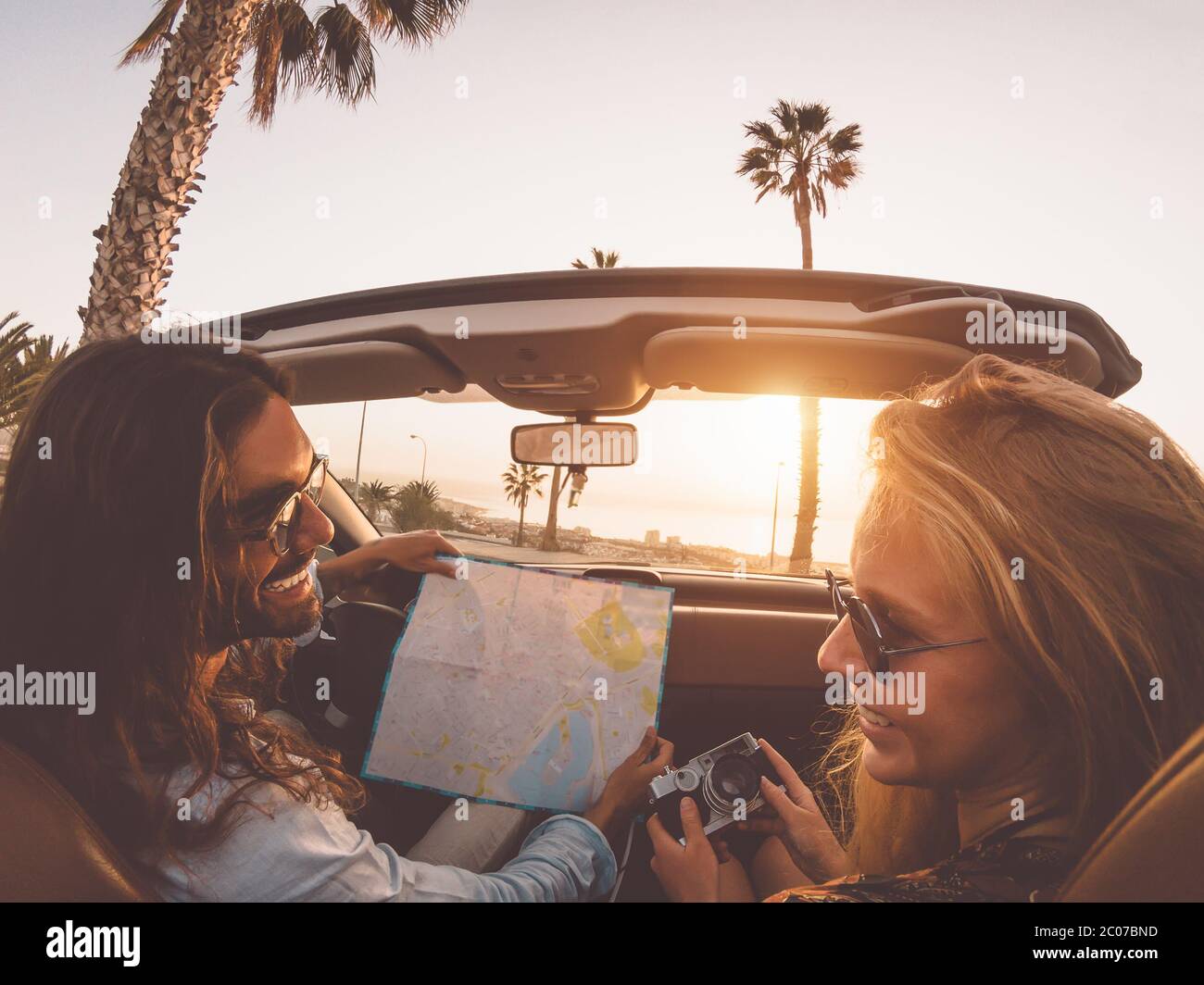 Happy young couple doing road trip in tropical city - Travel people ...