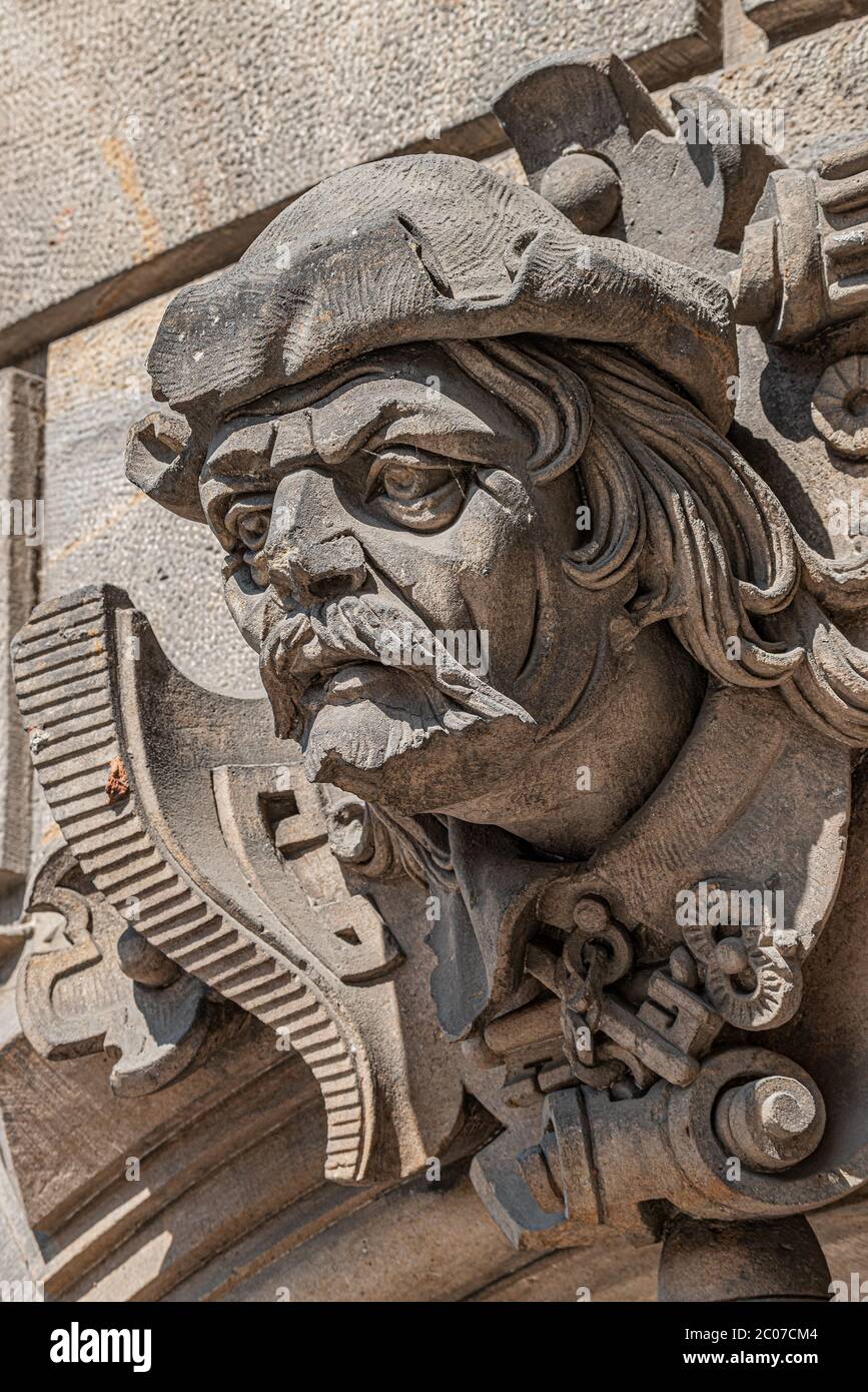 Very old statute of scary and heavy armed gatekeeper, medieval warrior ...