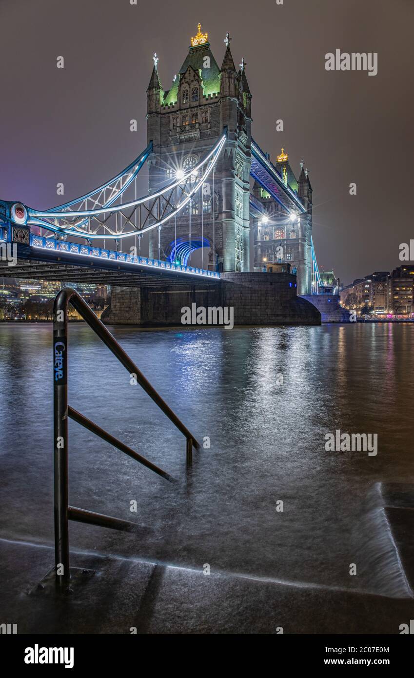 Tower Bridge with incoming tide at night Stock Photo - Alamy