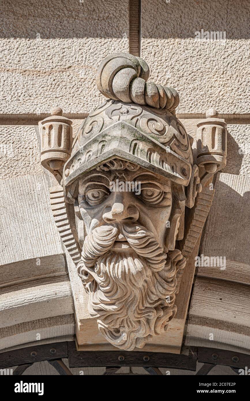 Very old statute of scary and heavy armed gatekeeper, medieval warrior ...