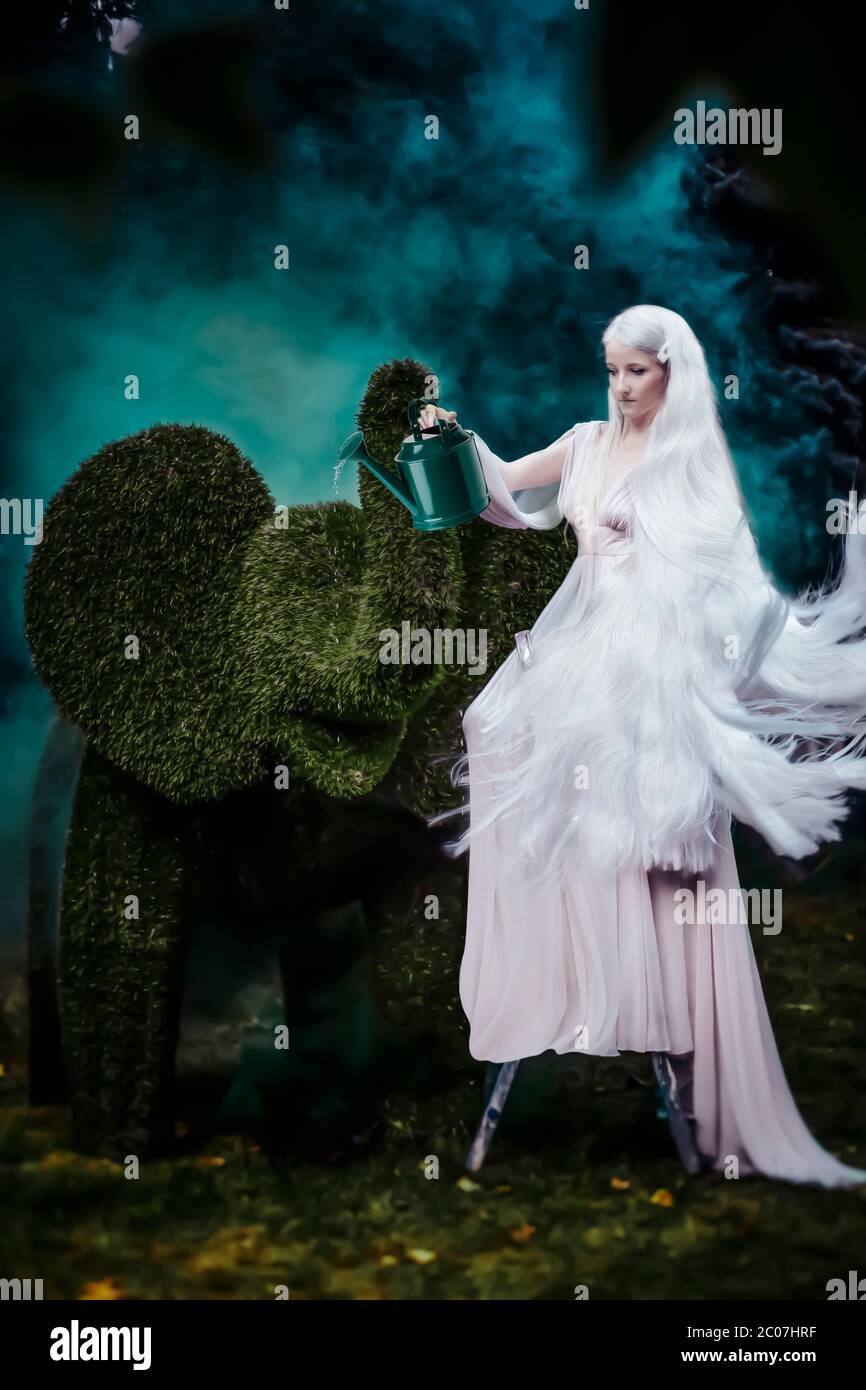 Beautiful woman with topiary bushes Stock Photo - Alamy